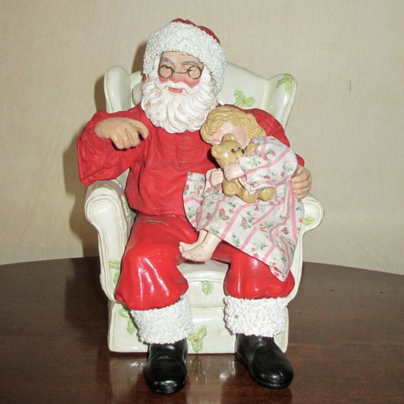 Julenisse med sovende barn på fanget - Epla